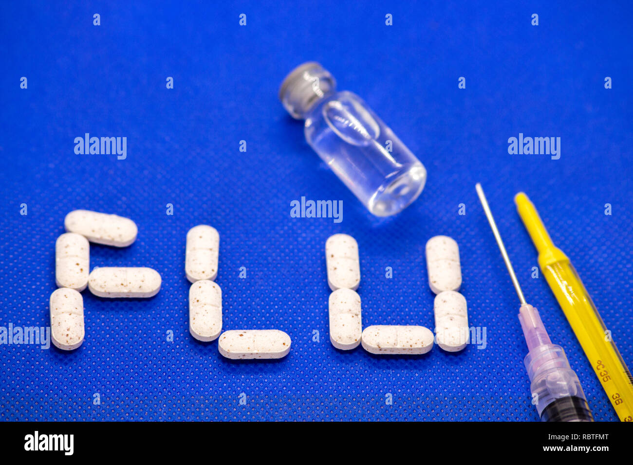Set of cold medicine and flu virus on blue background. Antibiotics ...