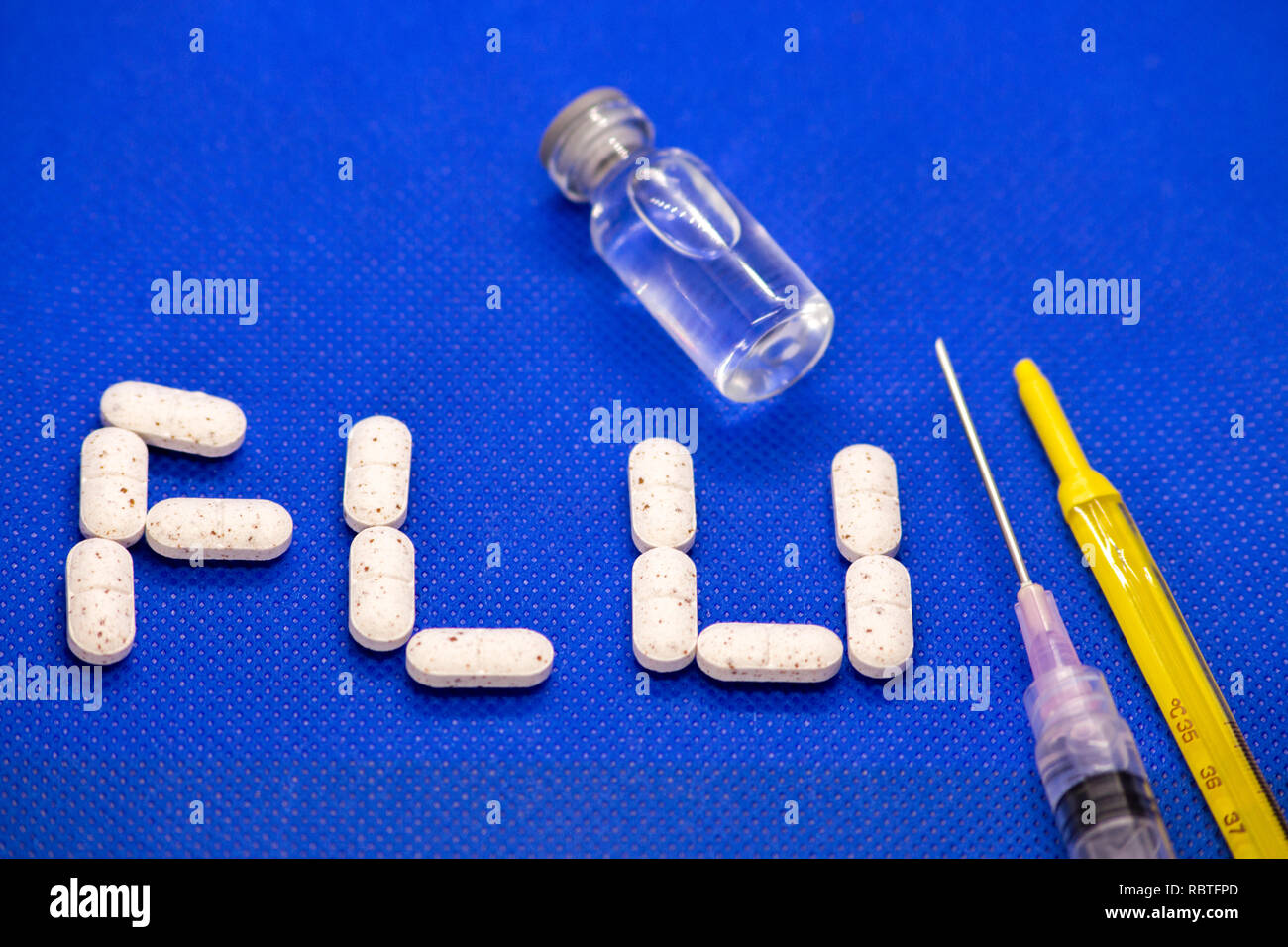 Set of cold medicine and flu virus on blue background. Antibiotics ...