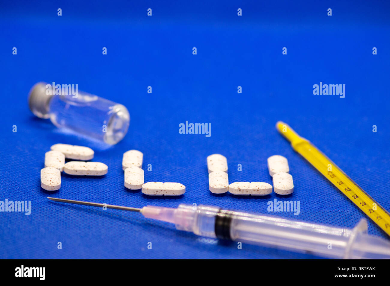 Set of cold medicine and flu virus on blue background. Antibiotics ...