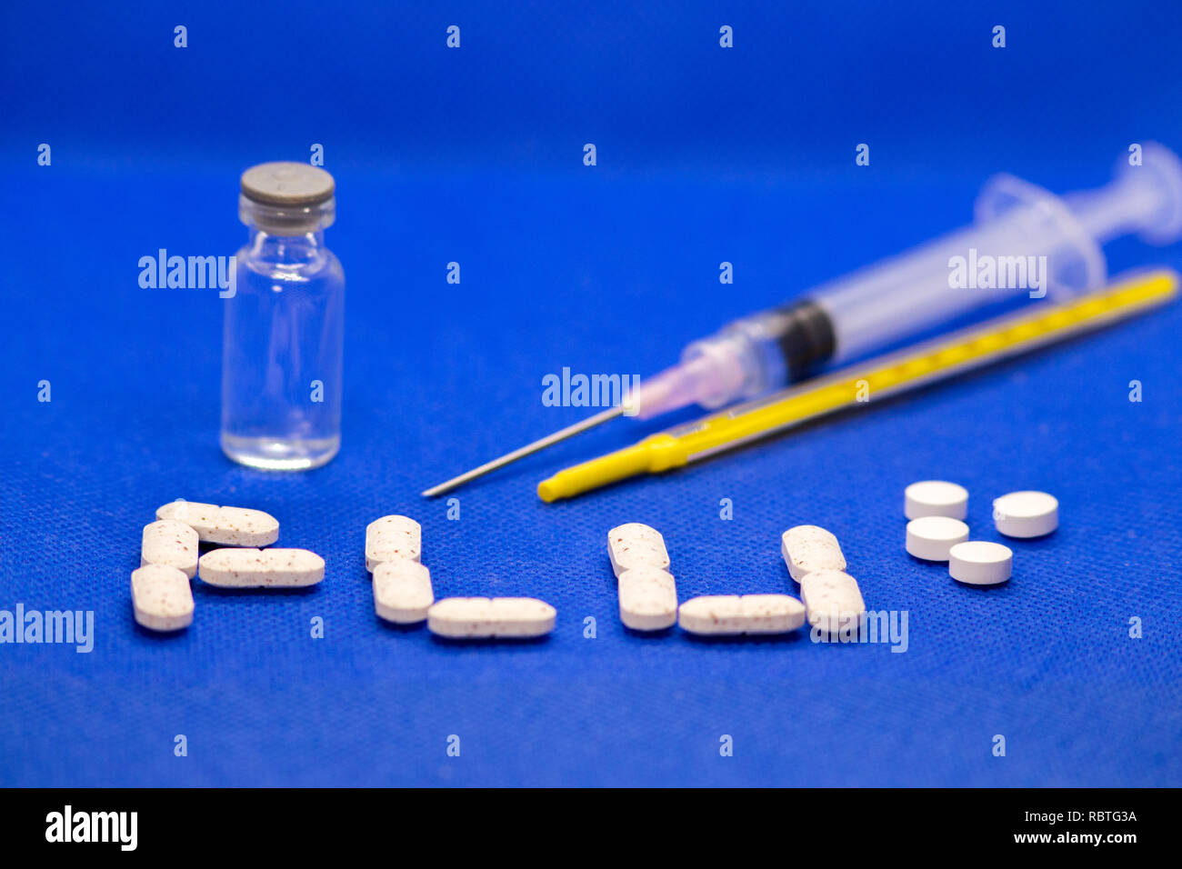 Set of cold medicine and flu virus on blue background. Antibiotics ...