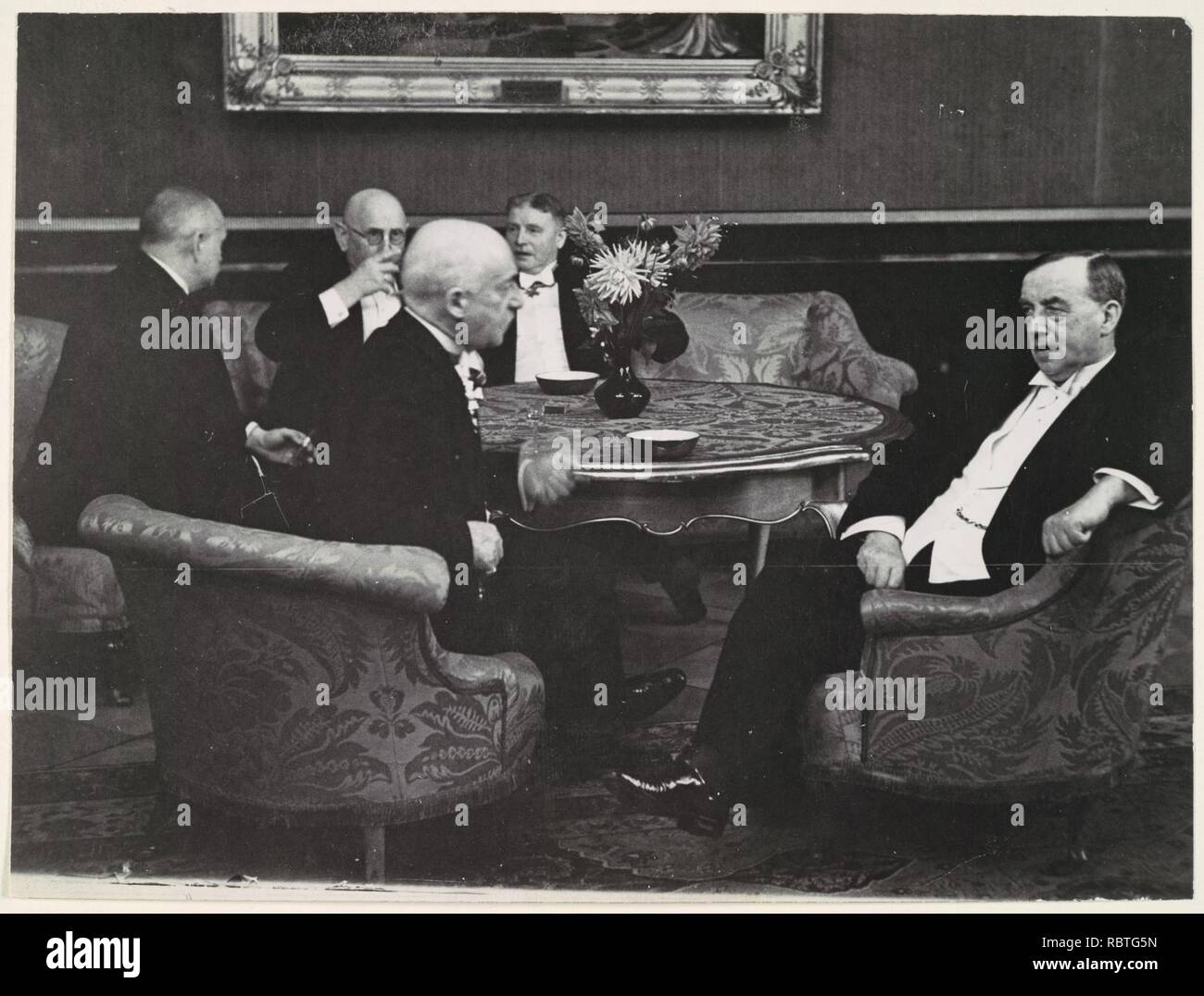 -Five Gentlemen Conversing around Table Stock Photo - Alamy