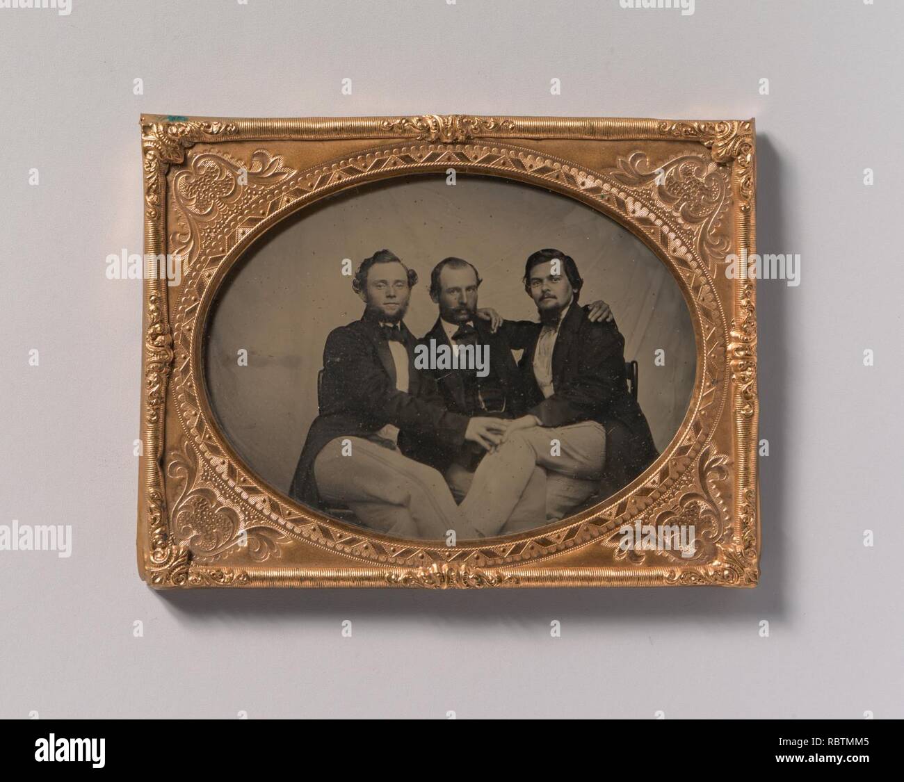 -Three Seated Men with Arms Around Each Other Stock Photo - Alamy