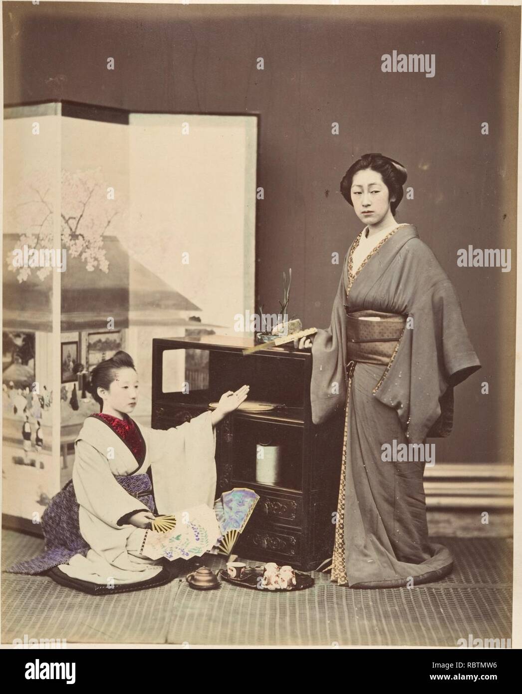 -Two Japanese Women Posing with Fans Stock Photo - Alamy