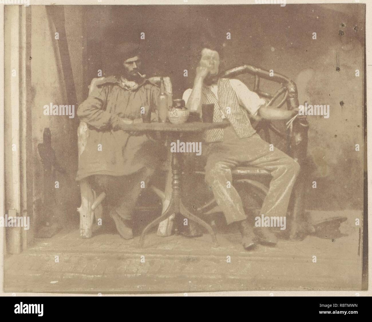 -Two Men Seated at a Table Stock Photo - Alamy