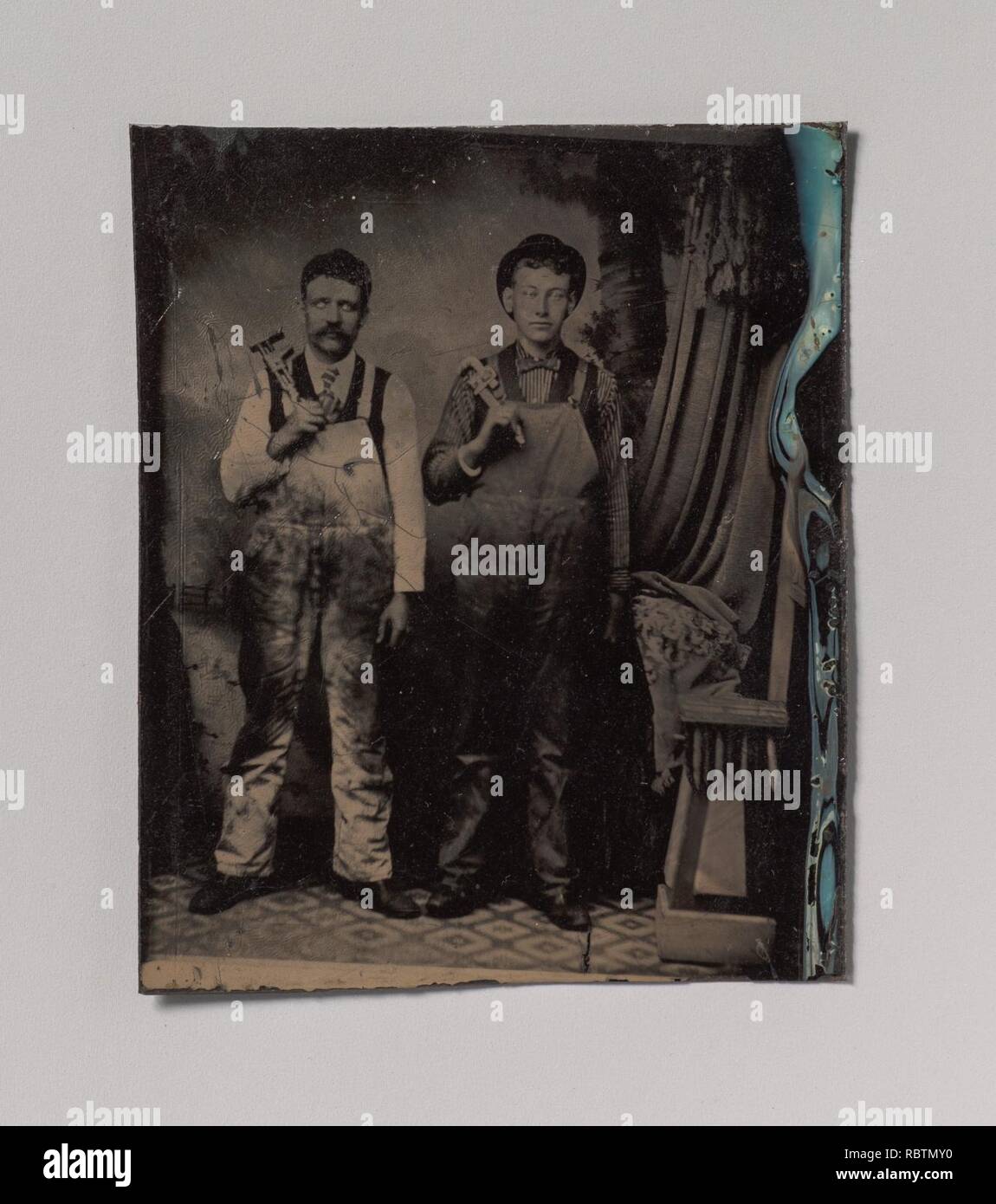 -Two Plumbers in Overalls Stock Photo - Alamy