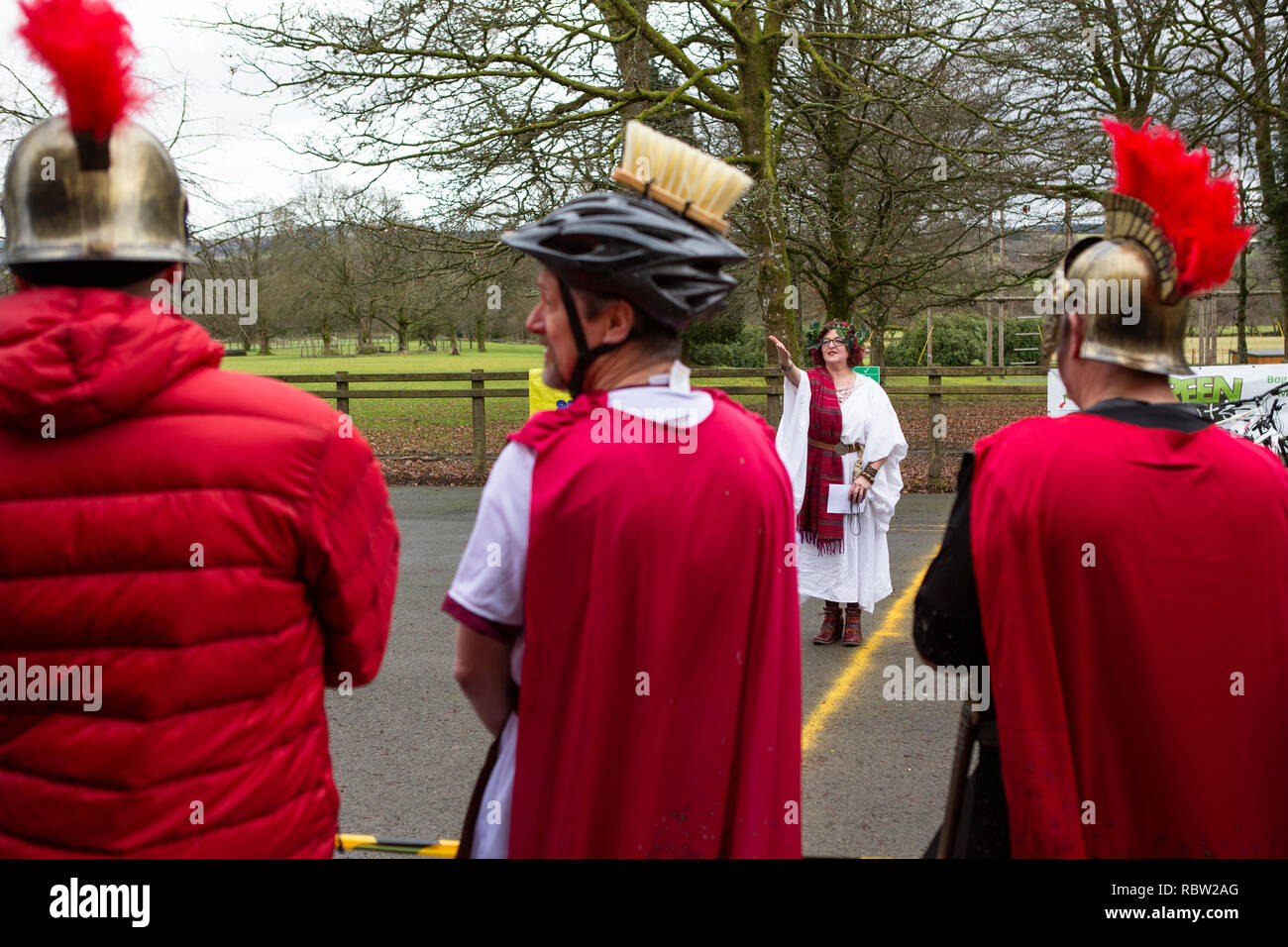 A woman in a Roman fancy dress toga addresses competitors before a ...