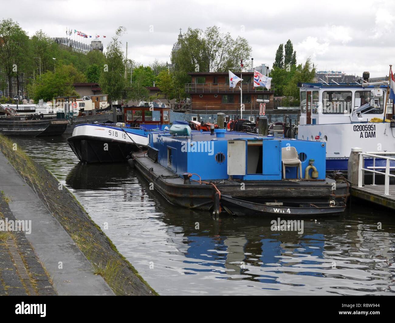 A group of municipal work boats on the quay of the Prins Hendrikkade in ...