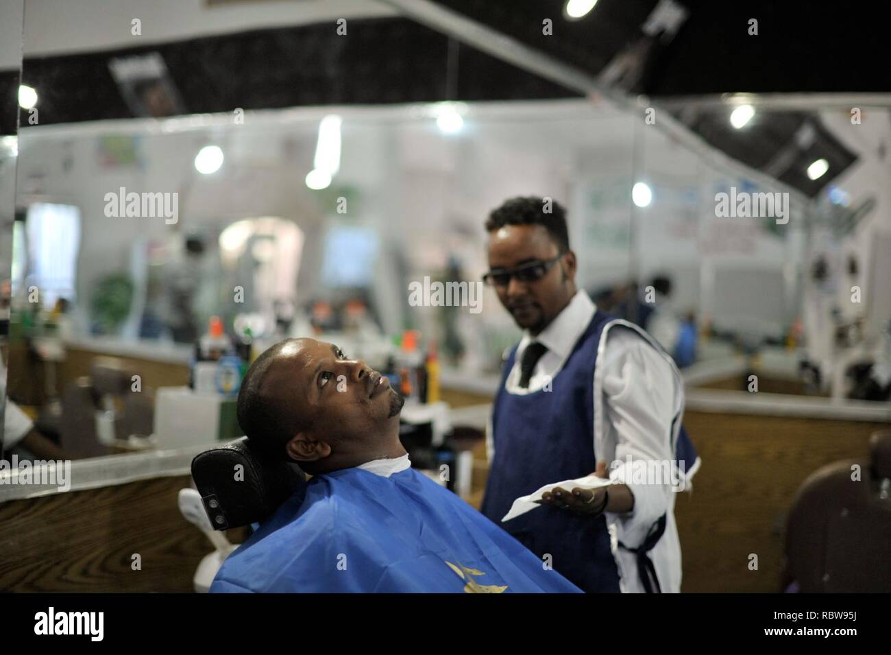 A hairdresser gives a client a facial at Abdulqadir Abdul's newly ...