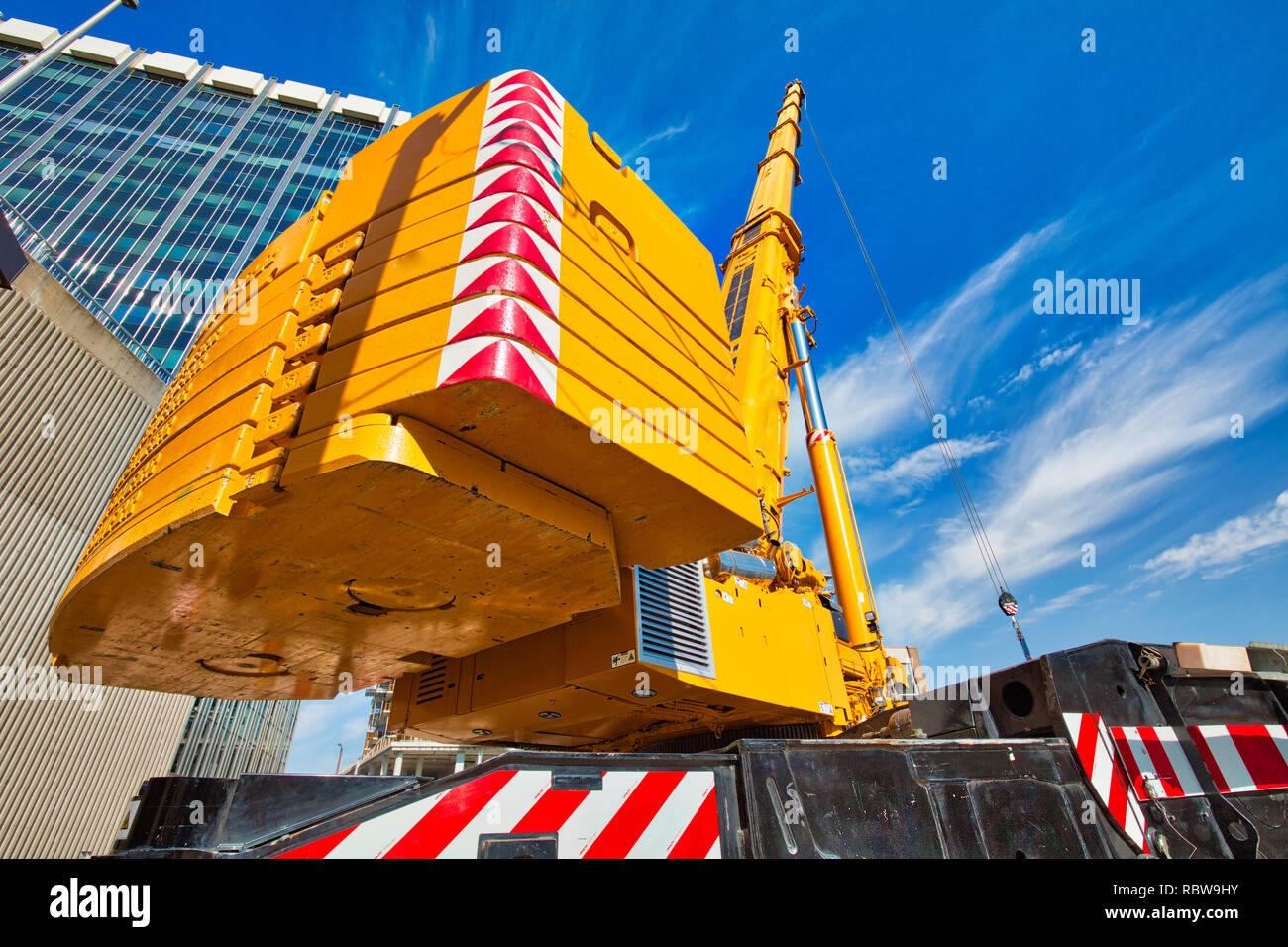 Mobile crane at work at downtown construction site Stock Photo - Alamy