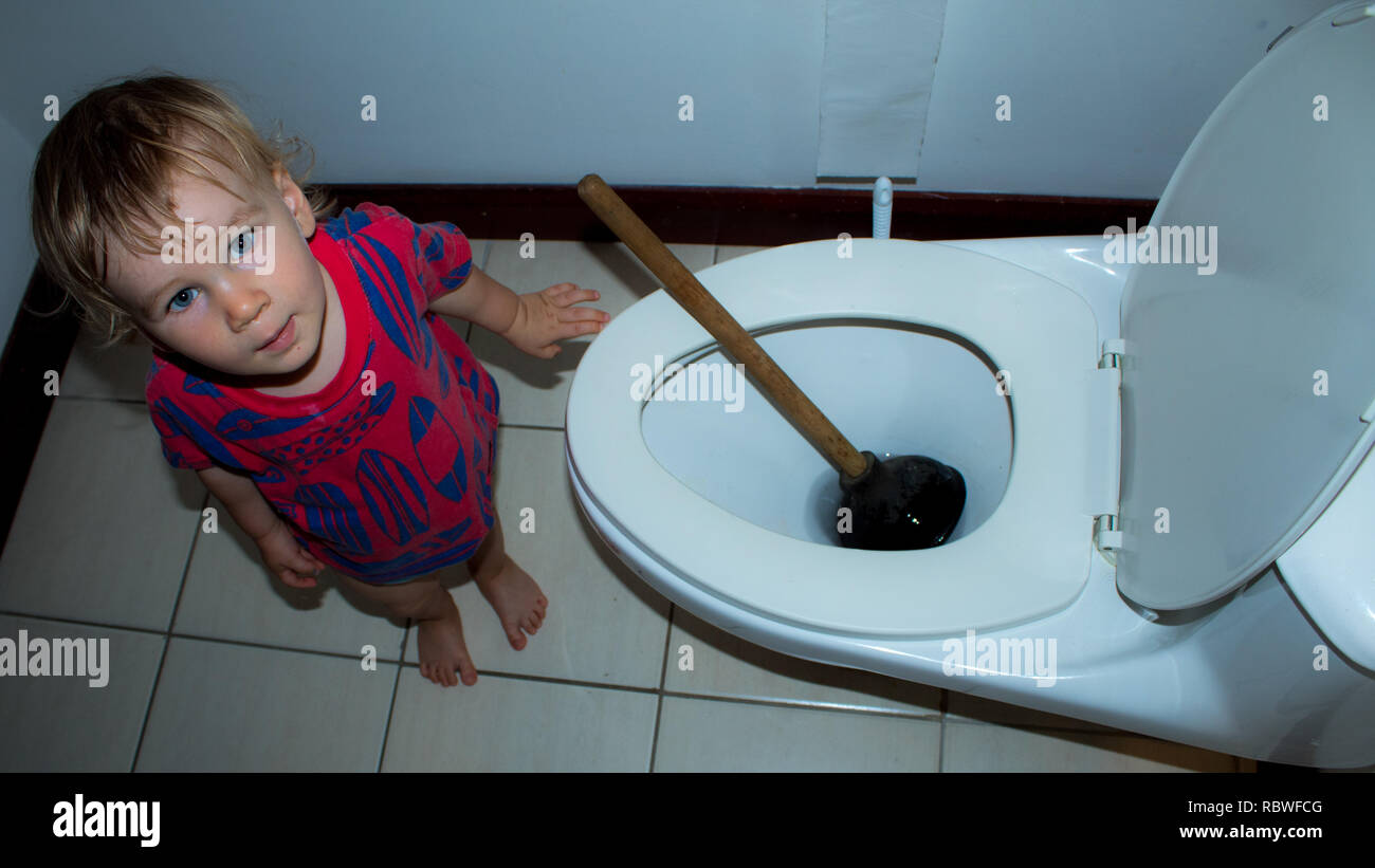 A nice photo of a little boy cleaning the toilet Stock Photo - Alamy