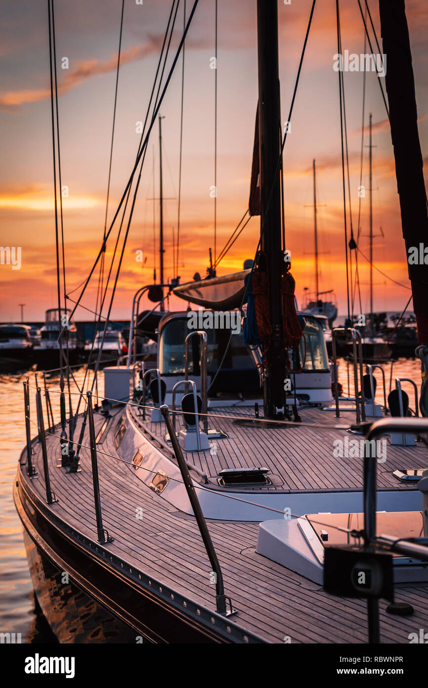 Sailboat with wooden deck standing in marine at beautiful sunset Stock ...