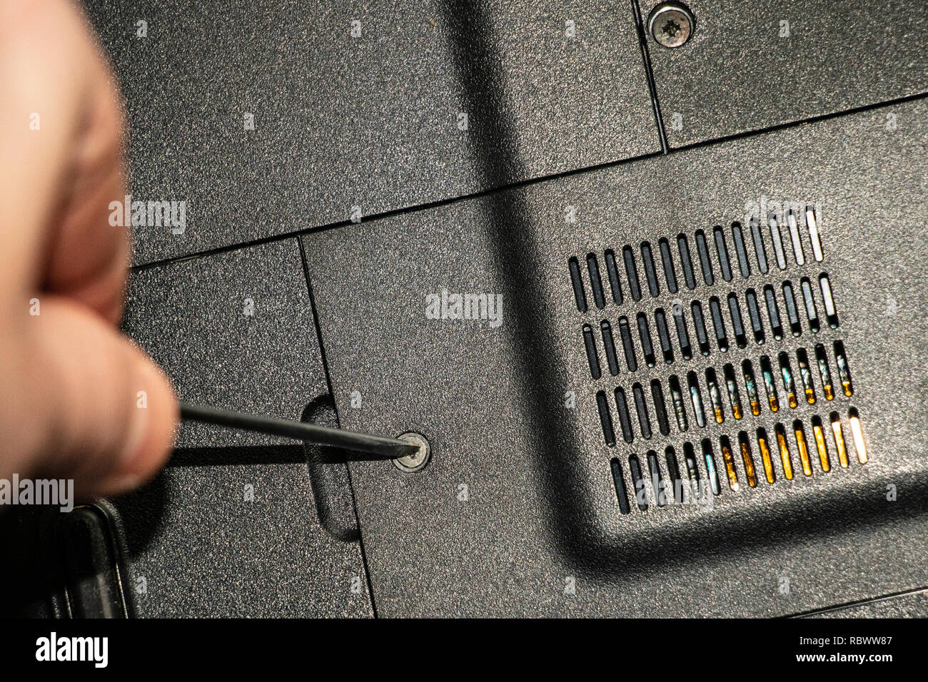 Repairing old laptop PC. Person repairs old PC, disassembles its parts ...