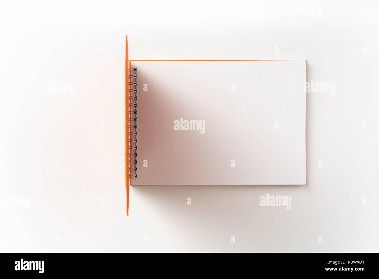 Design concept - Top view orange hardcover spiral notebook with open ...