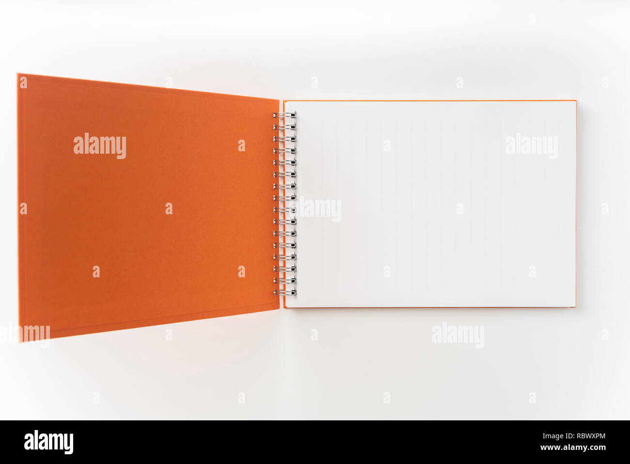 Design concept - Top view orange hardcover spiral notebook with open ...
