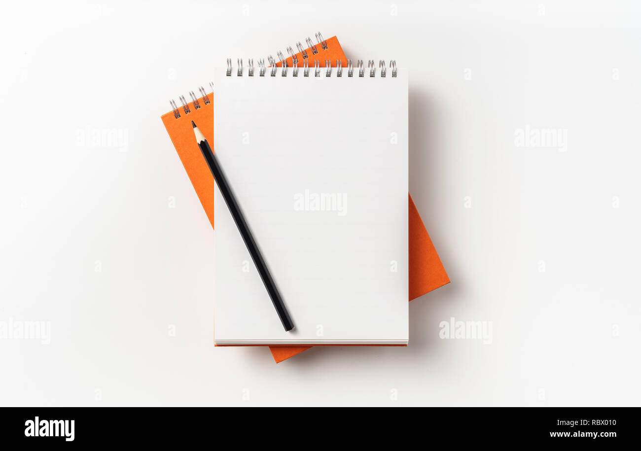 Design concept - Top view of 2 orange spiral notebook, white page and ...