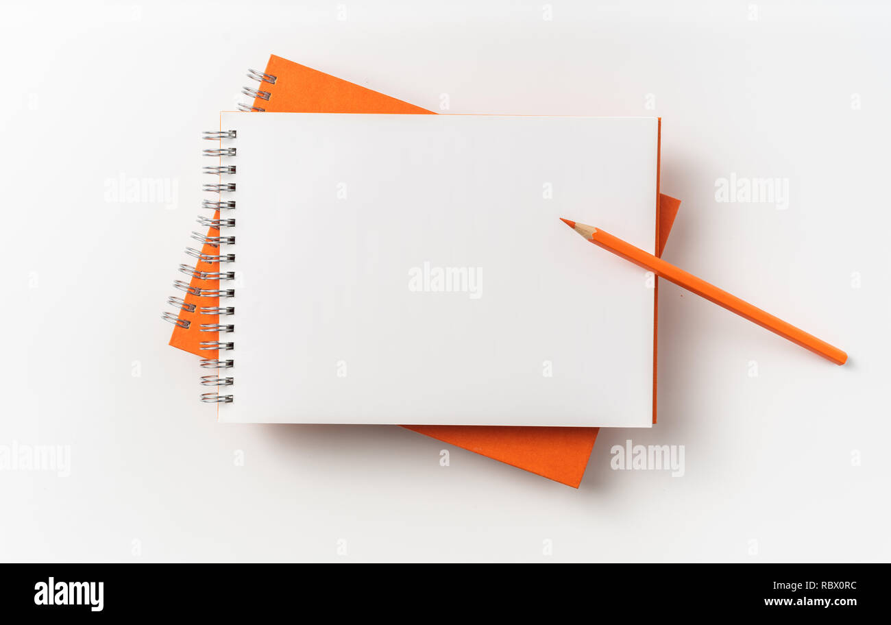 Design concept - Top view of 2 orange spiral notebook, white page and ...