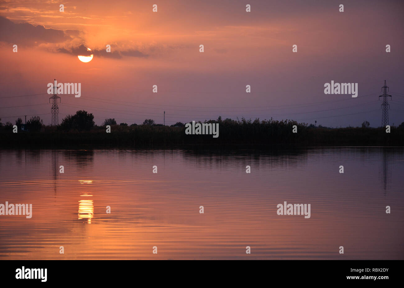 Amazing sunset sky in the evening and sunlight reflection on water ...