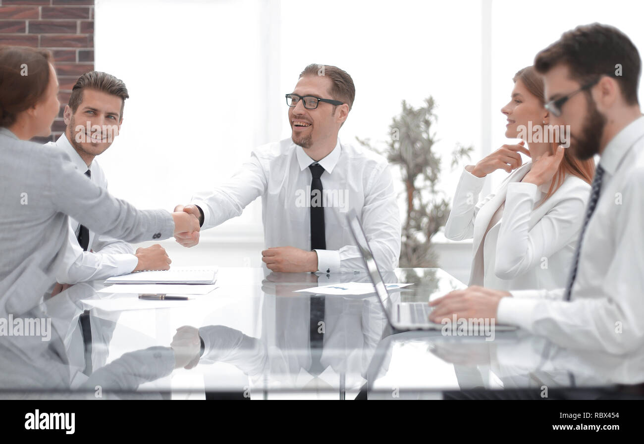 Manager shaking hands with a young business woman Stock Photo - Alamy