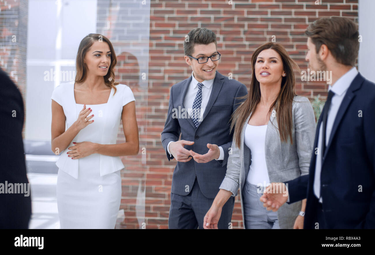 business team talking standing in the office corridor Stock Photo - Alamy