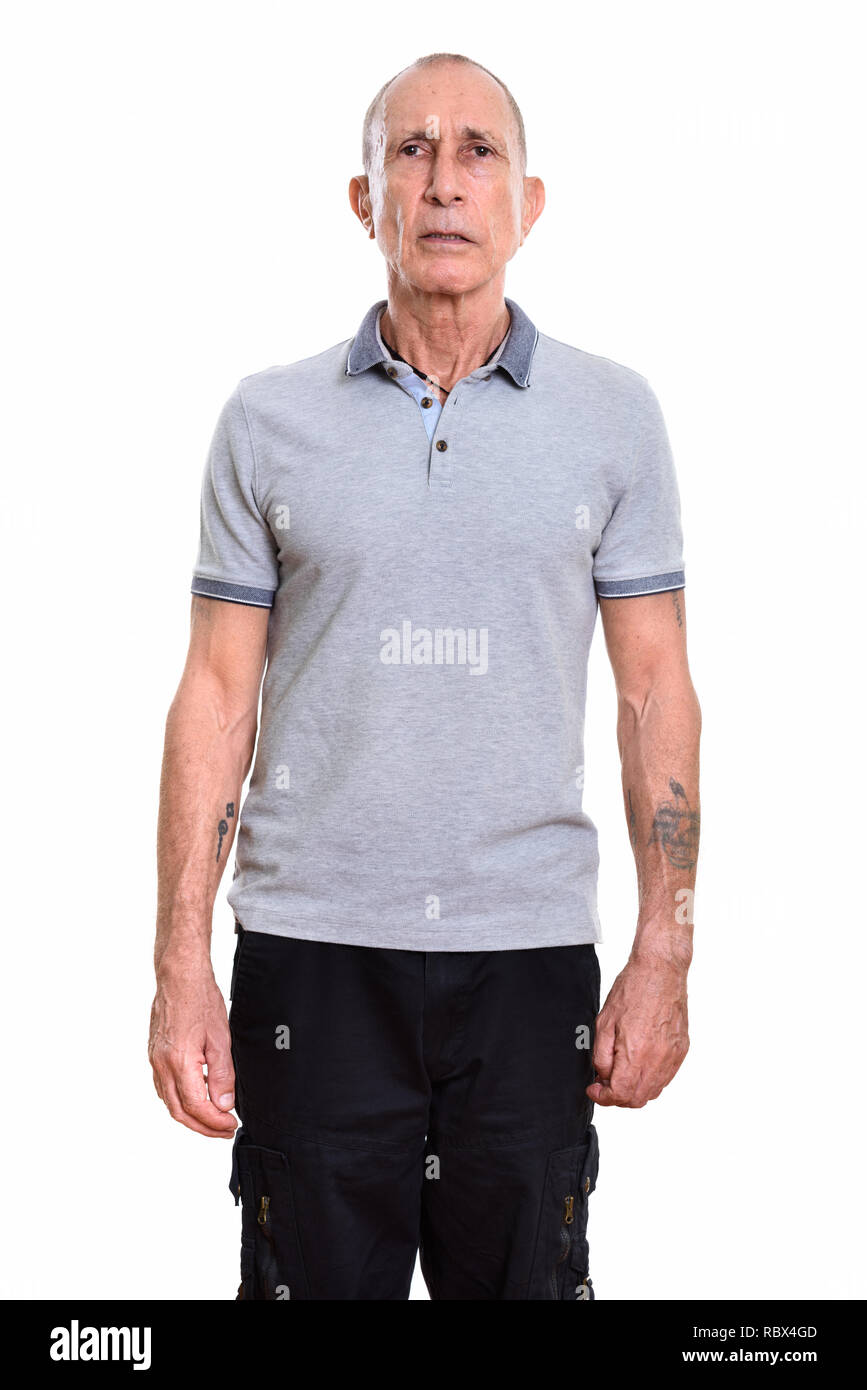 Studio shot of senior man standing isolated against white background ...