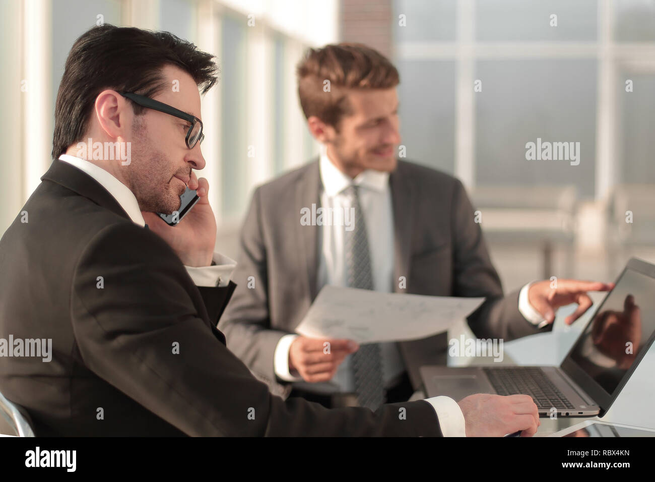employees use a laptop to check new data Stock Photo - Alamy