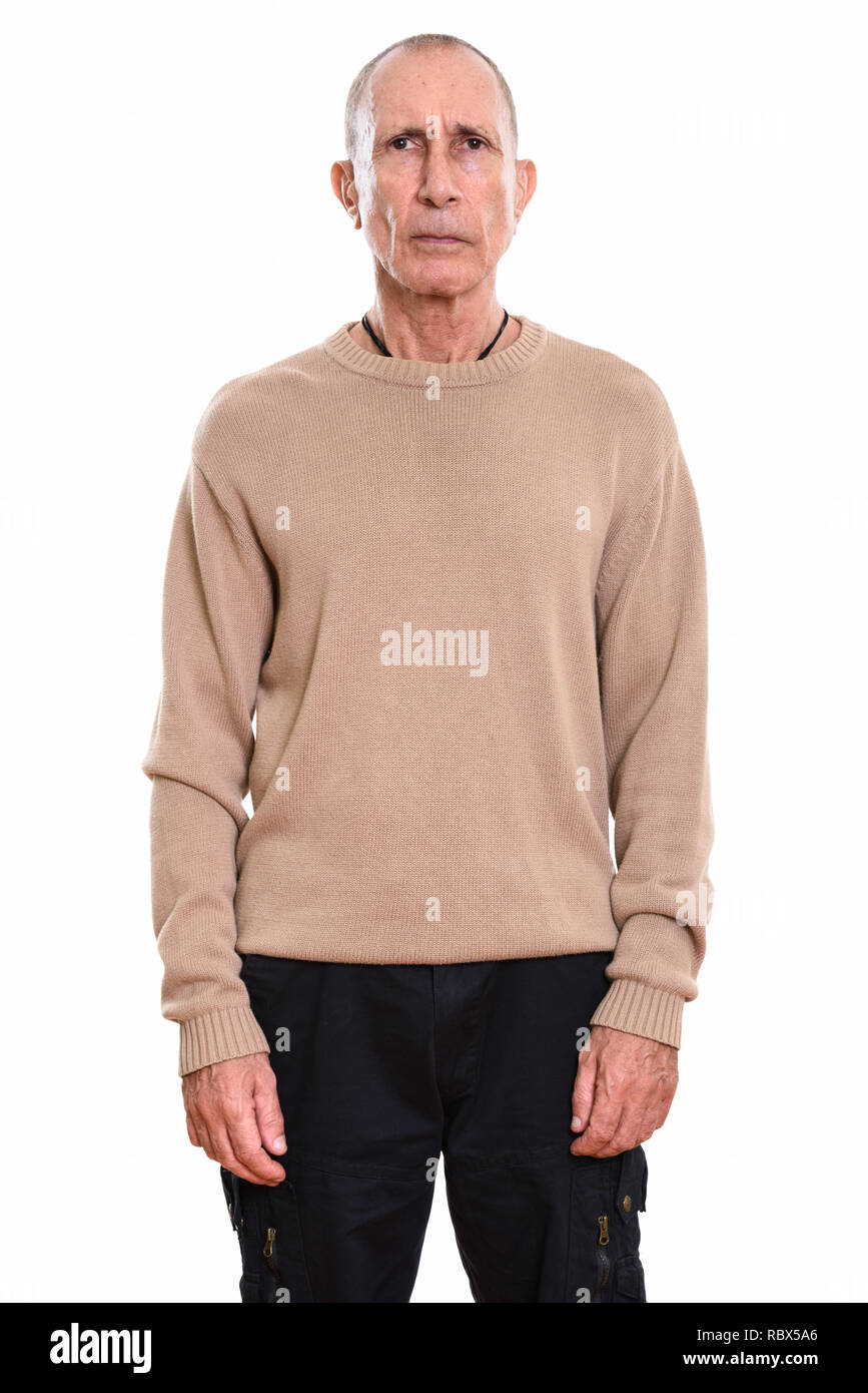 Studio shot of senior man standing isolated against white background ...