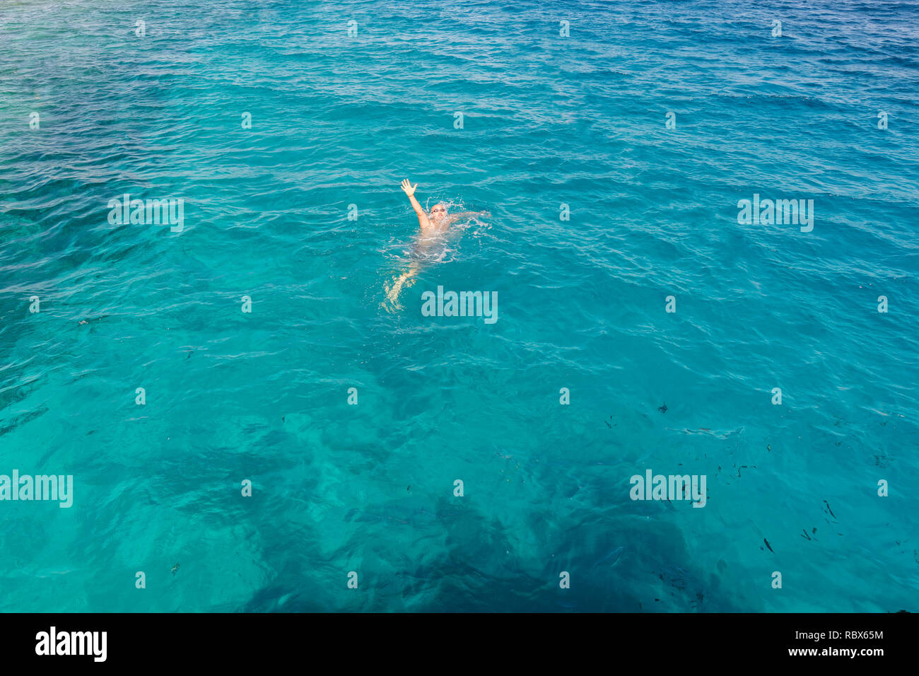 Man drowns in the sea. Drowning man in sea asking for help with raised ...