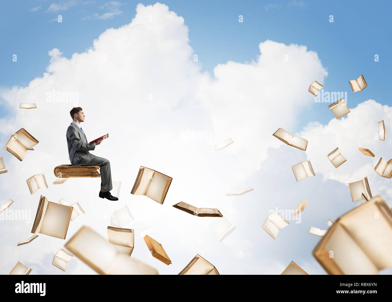 Man reading book and many of them flying in air Stock Photo - Alamy