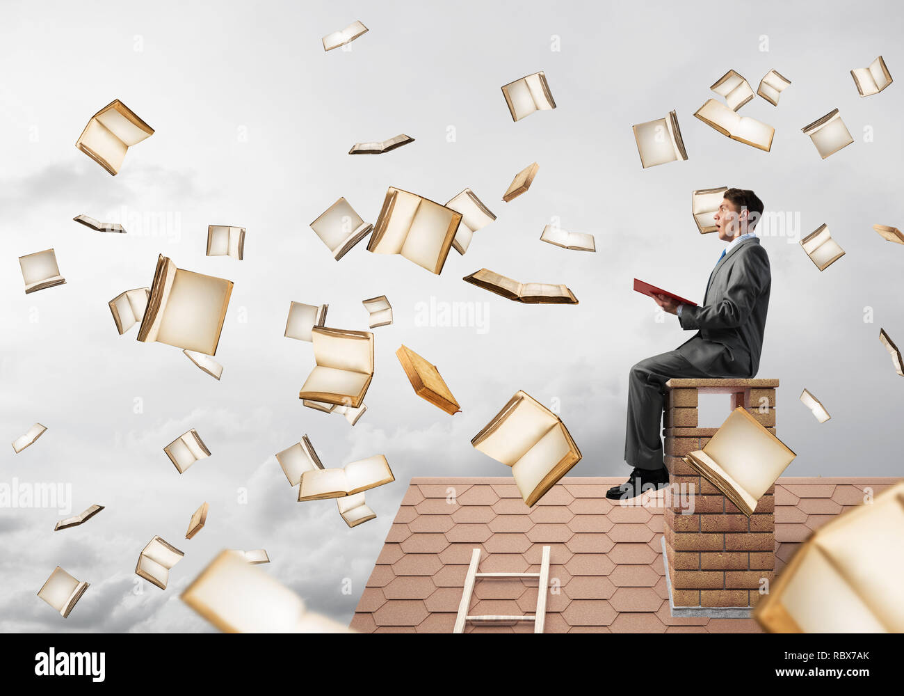 Man reading book and many of them flying in air Stock Photo - Alamy