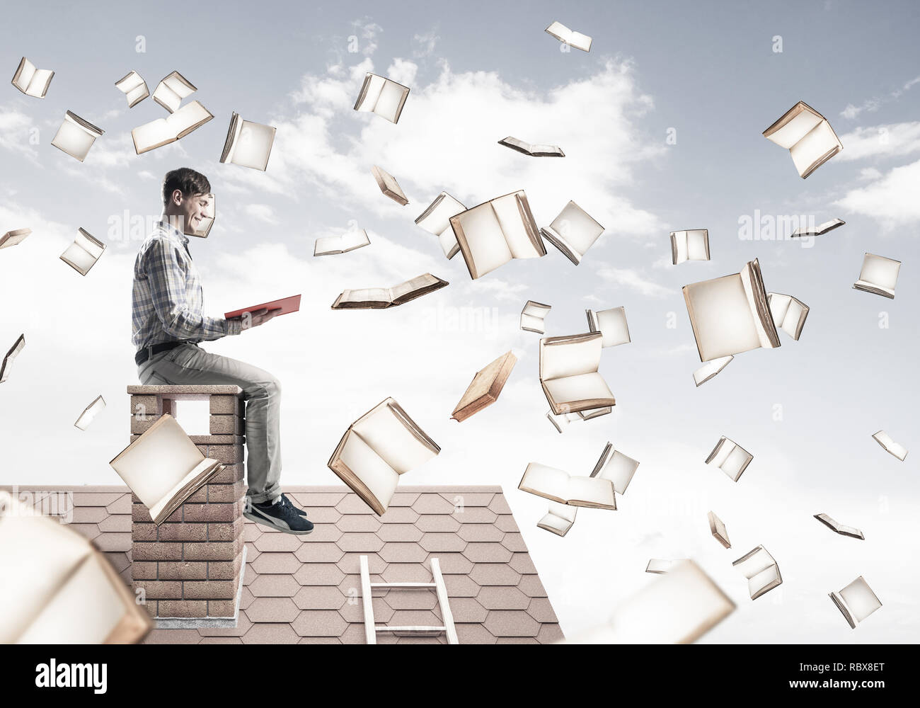 Man reading book and many of them flying in air Stock Photo - Alamy