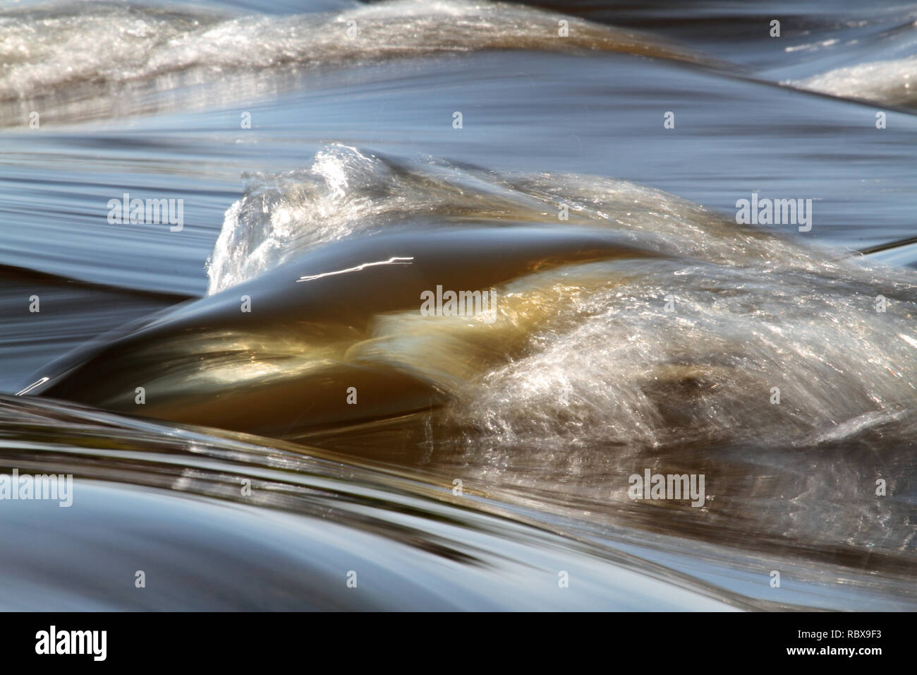 Water flowing smoothly over rocks in rapids Stock Photo - Alamy