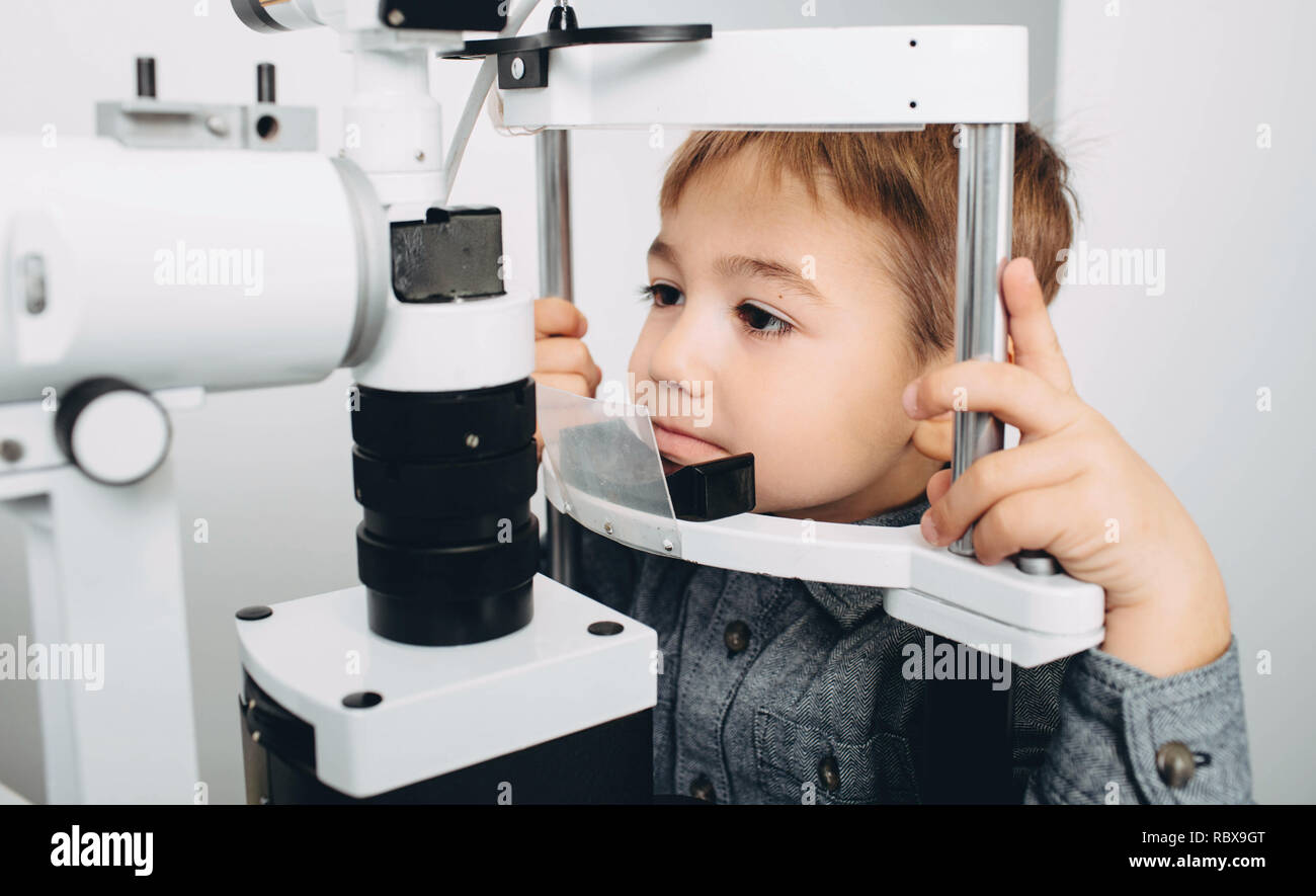 optometrist performing visual field test to little patient Stock Photo ...