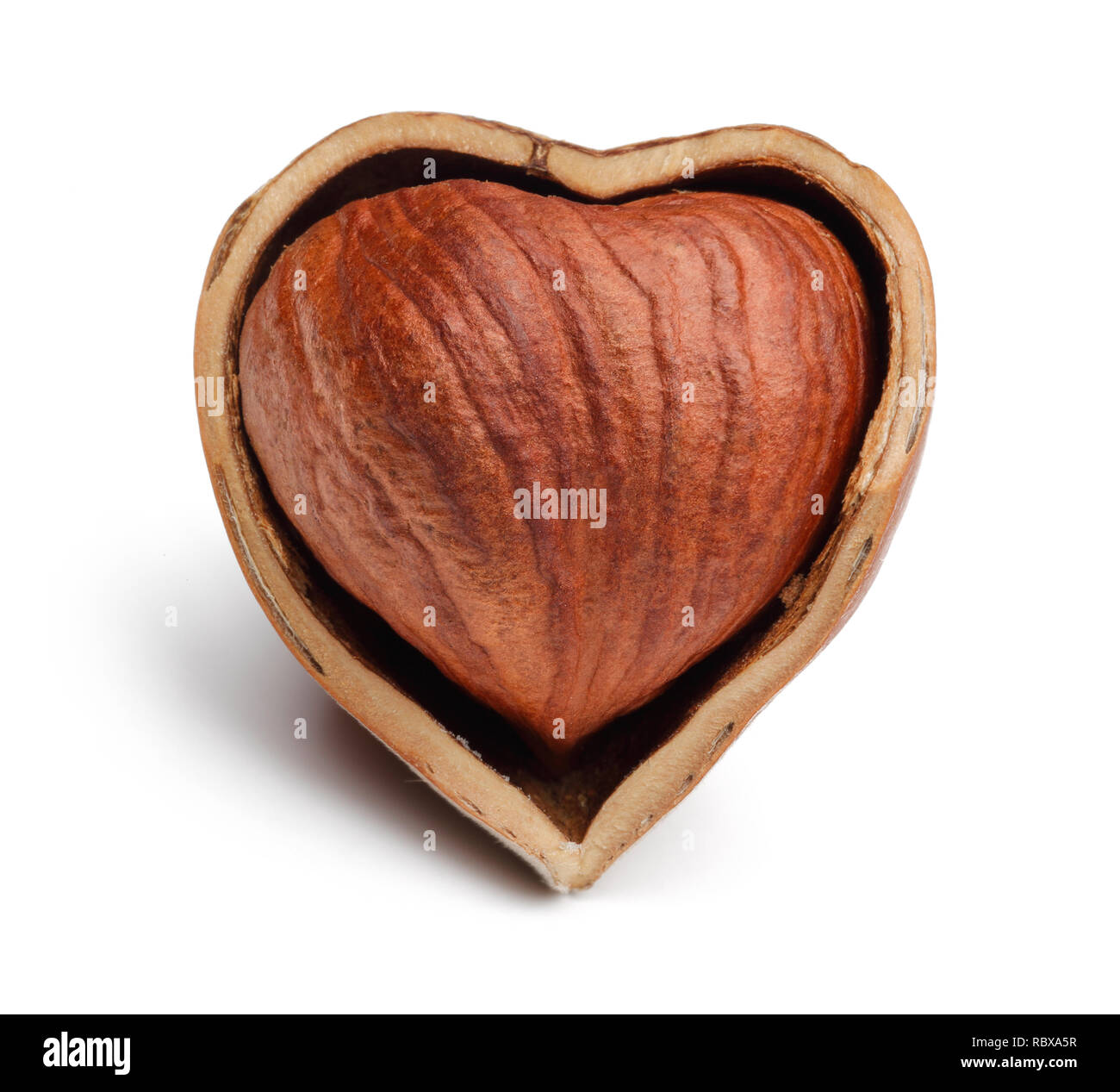 Heart shaped half hazelnut isolated on white background Stock Photo - Alamy