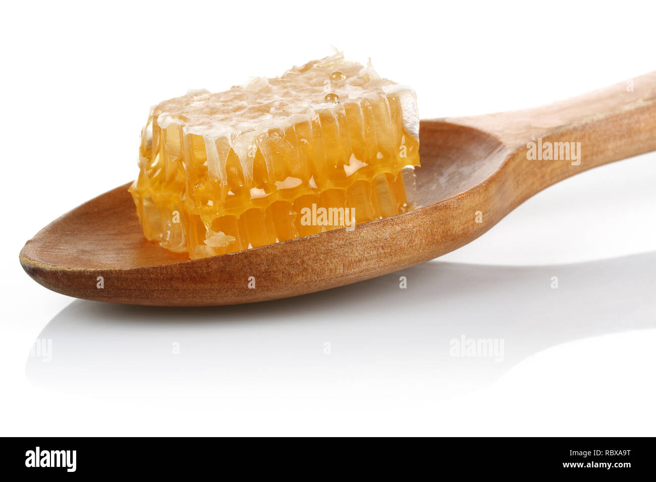 Honeycomb in wooden spoon isolated on white background Stock Photo - Alamy