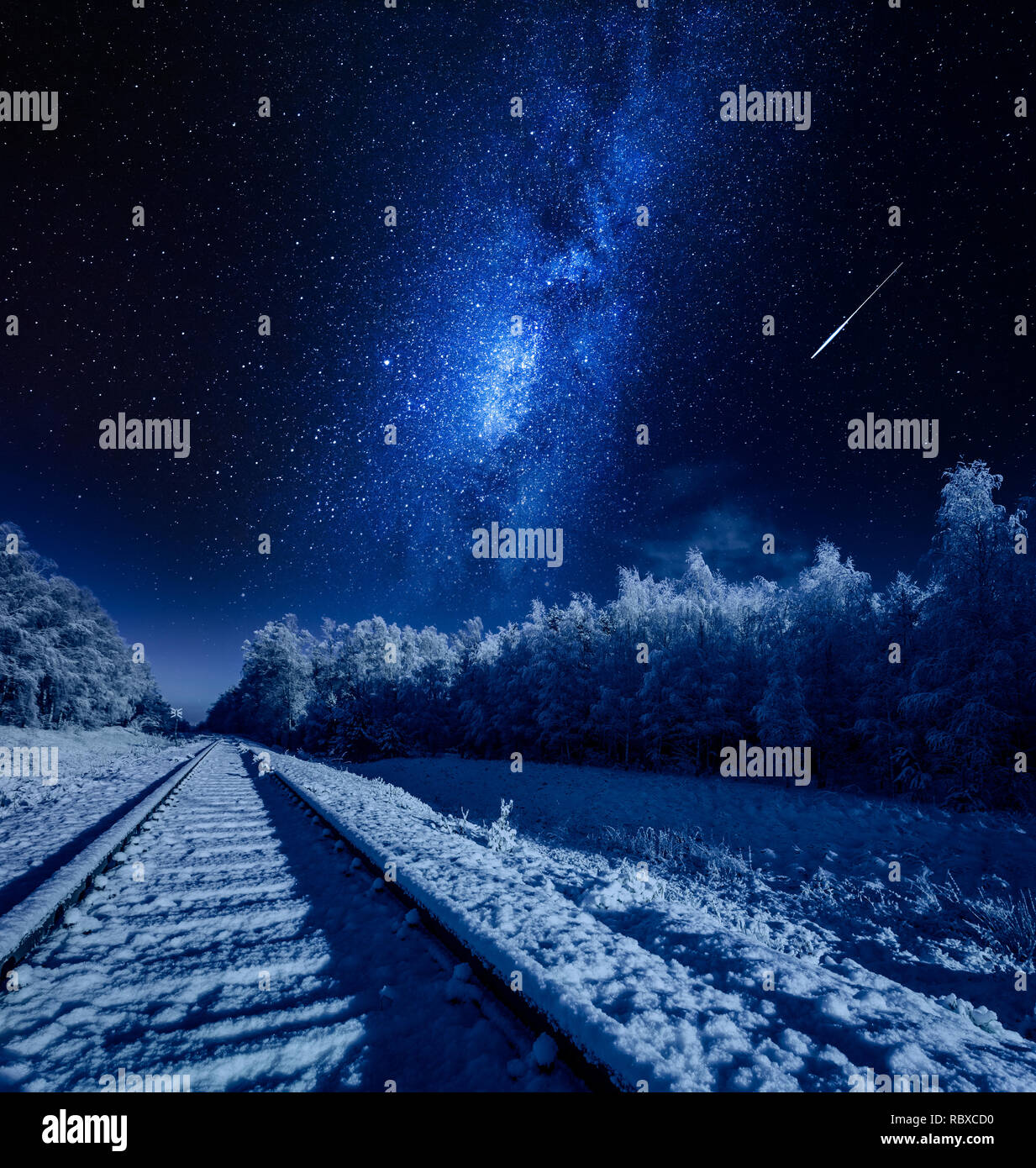 Milky way over frozen railway line in winter at night Stock Photo - Alamy