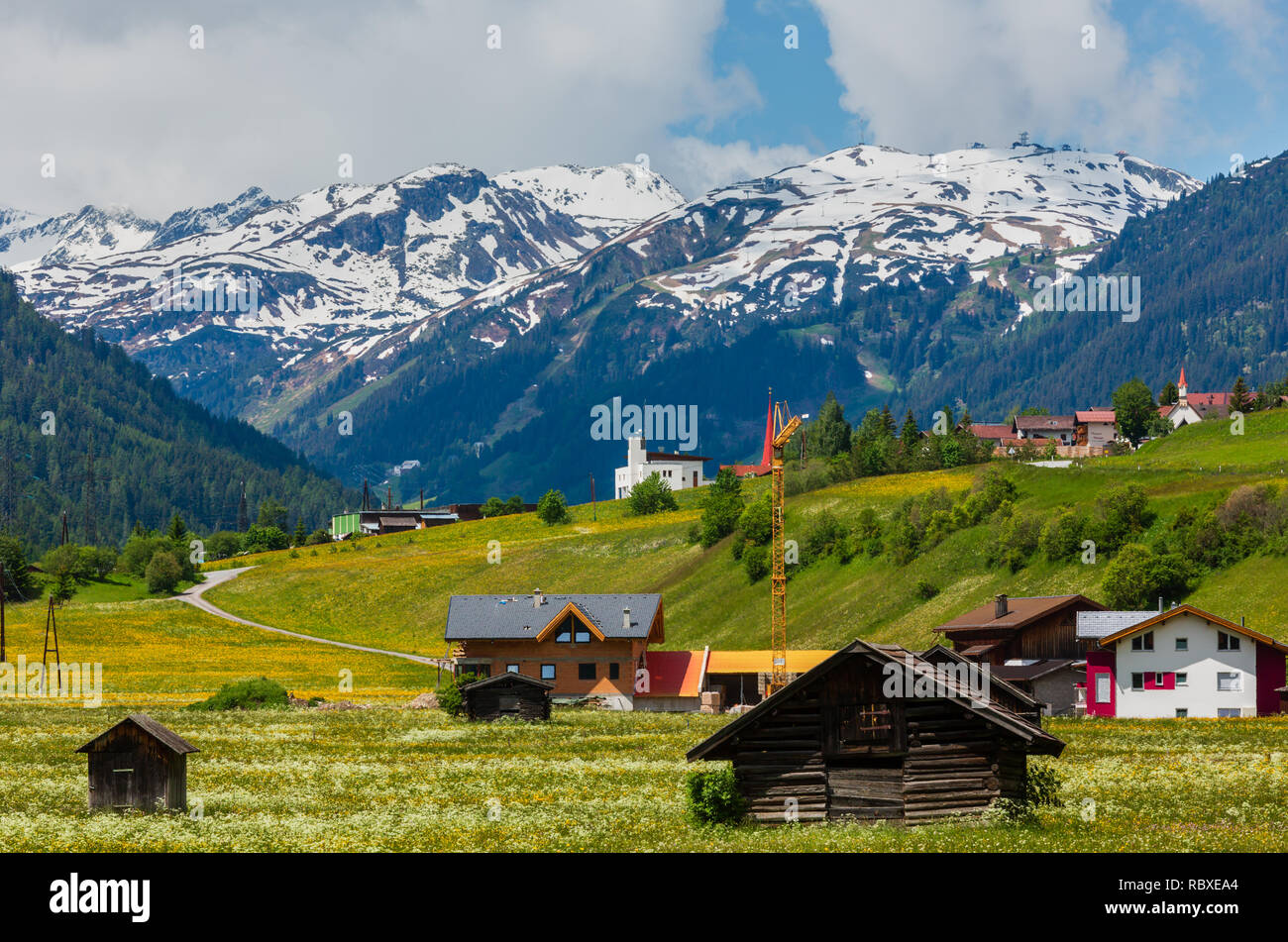 Summer Alpine mountain country view with grassy meadow and road to ...