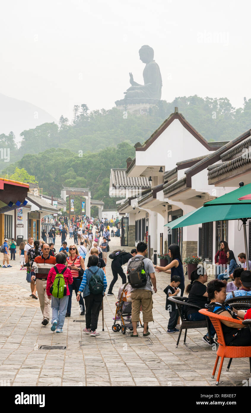 Ngong Ping village overlooked by haze covered Tian Tan Buddha, Lantau ...