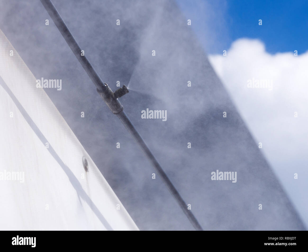 Working cooling system with water mist building Stock Photo - Alamy