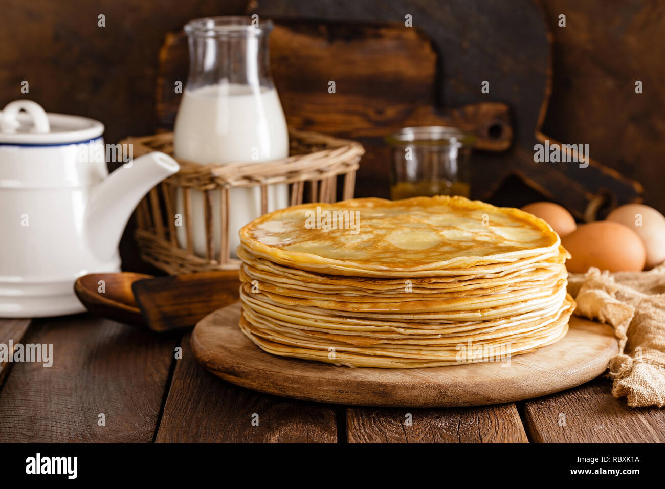 Homemade thin crepes with honey, pancakes on wooden rustic background ...