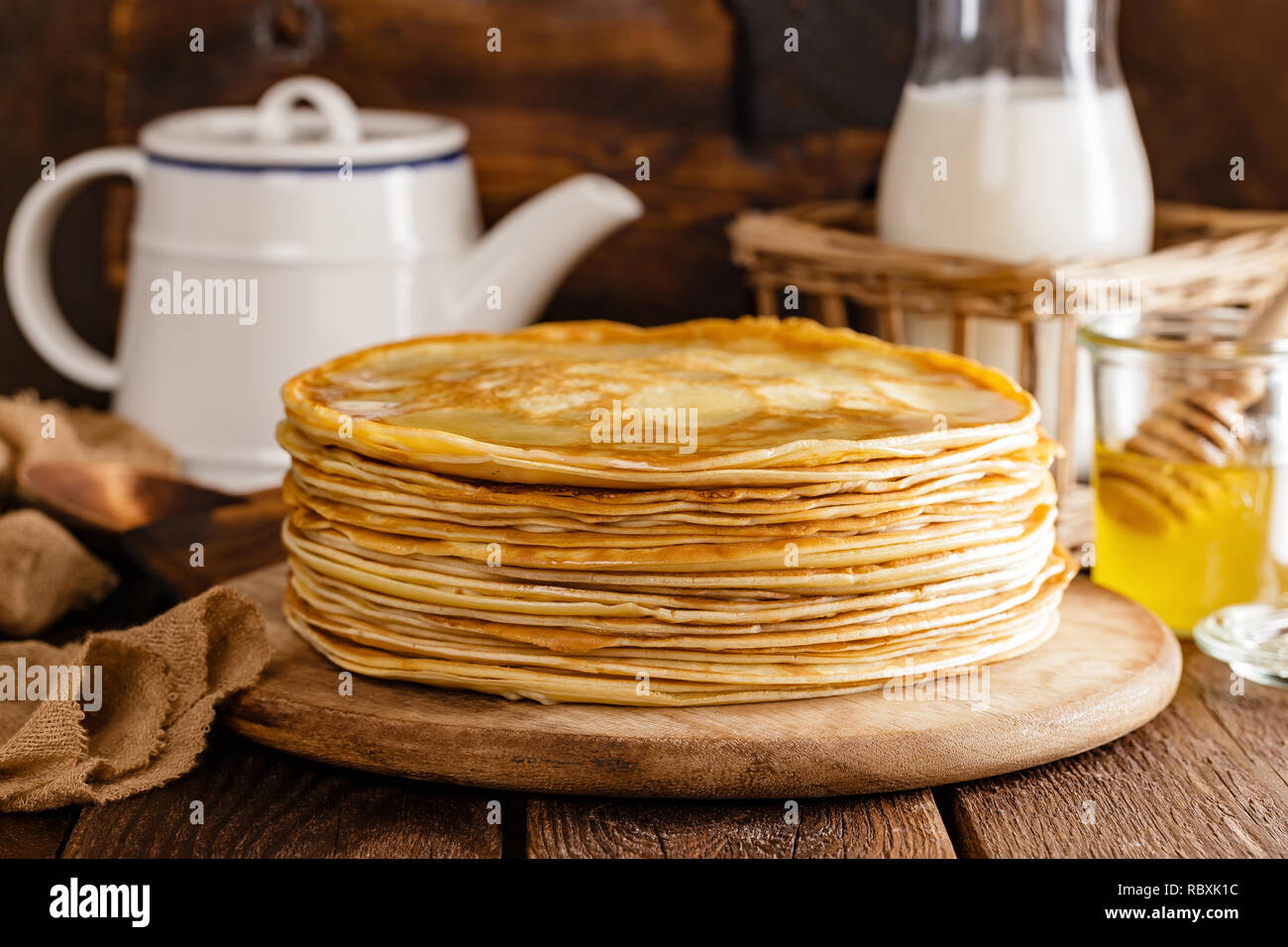 Homemade thin crepes with honey, pancakes on wooden rustic background ...