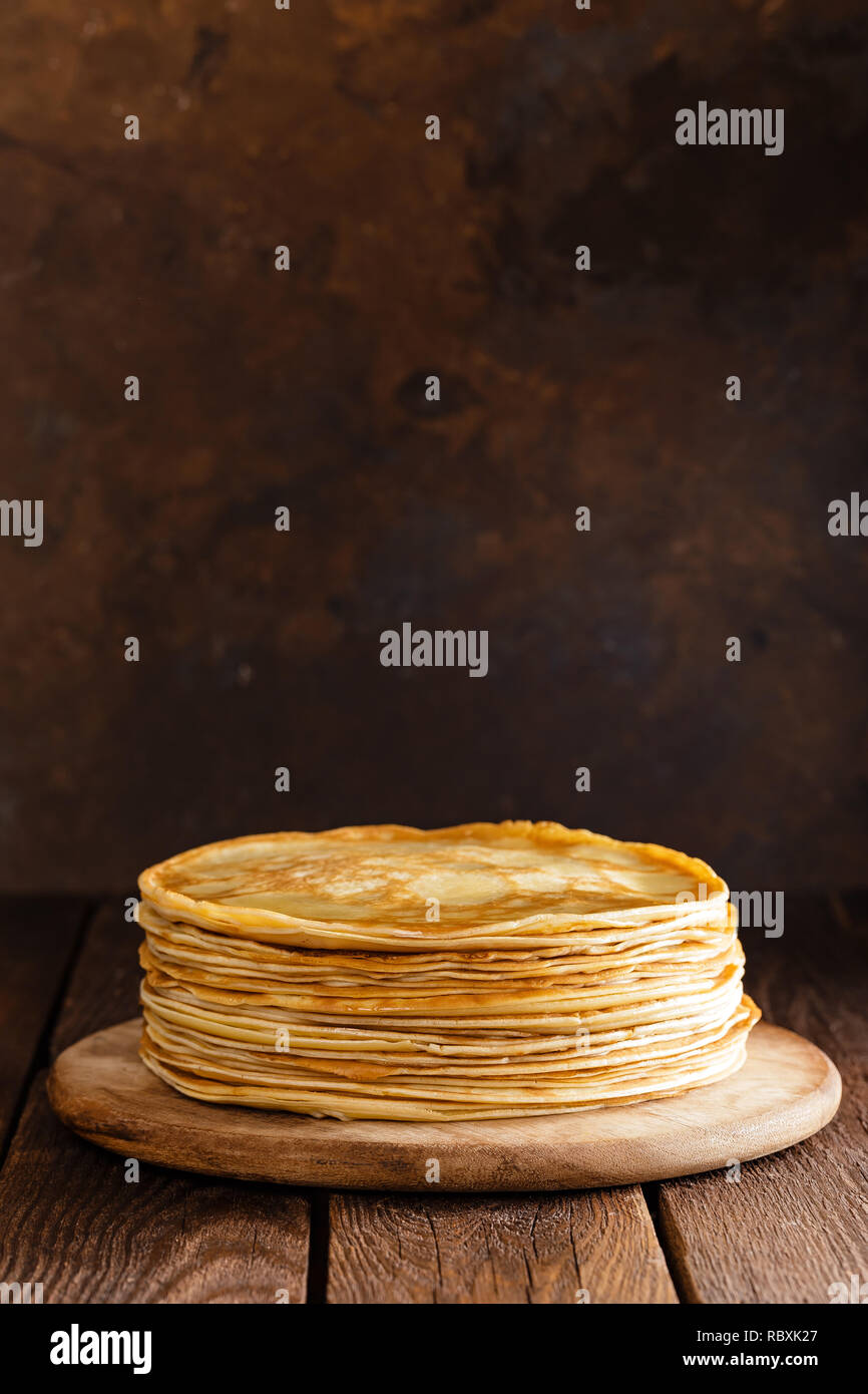 Homemade thin crepes with honey, pancakes on wooden rustic background ...