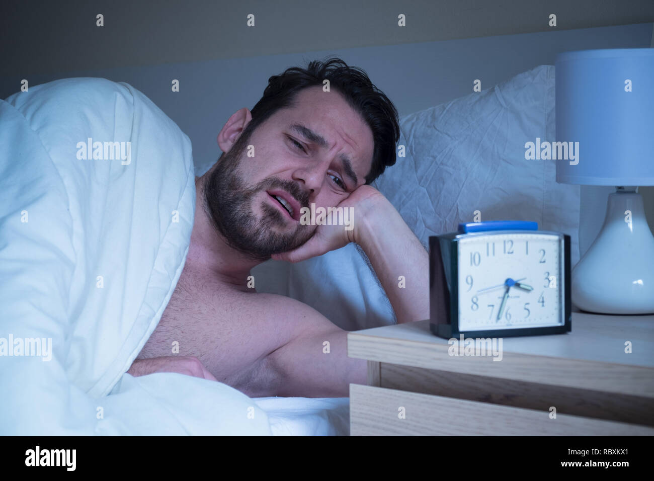 Stressed sleepless man expression lying in the bed Stock Photo - Alamy