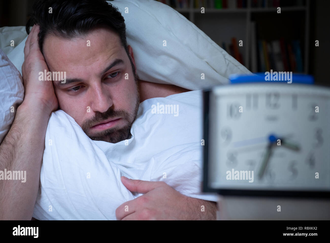 Stressed sleepless man expression lying in the bed Stock Photo - Alamy