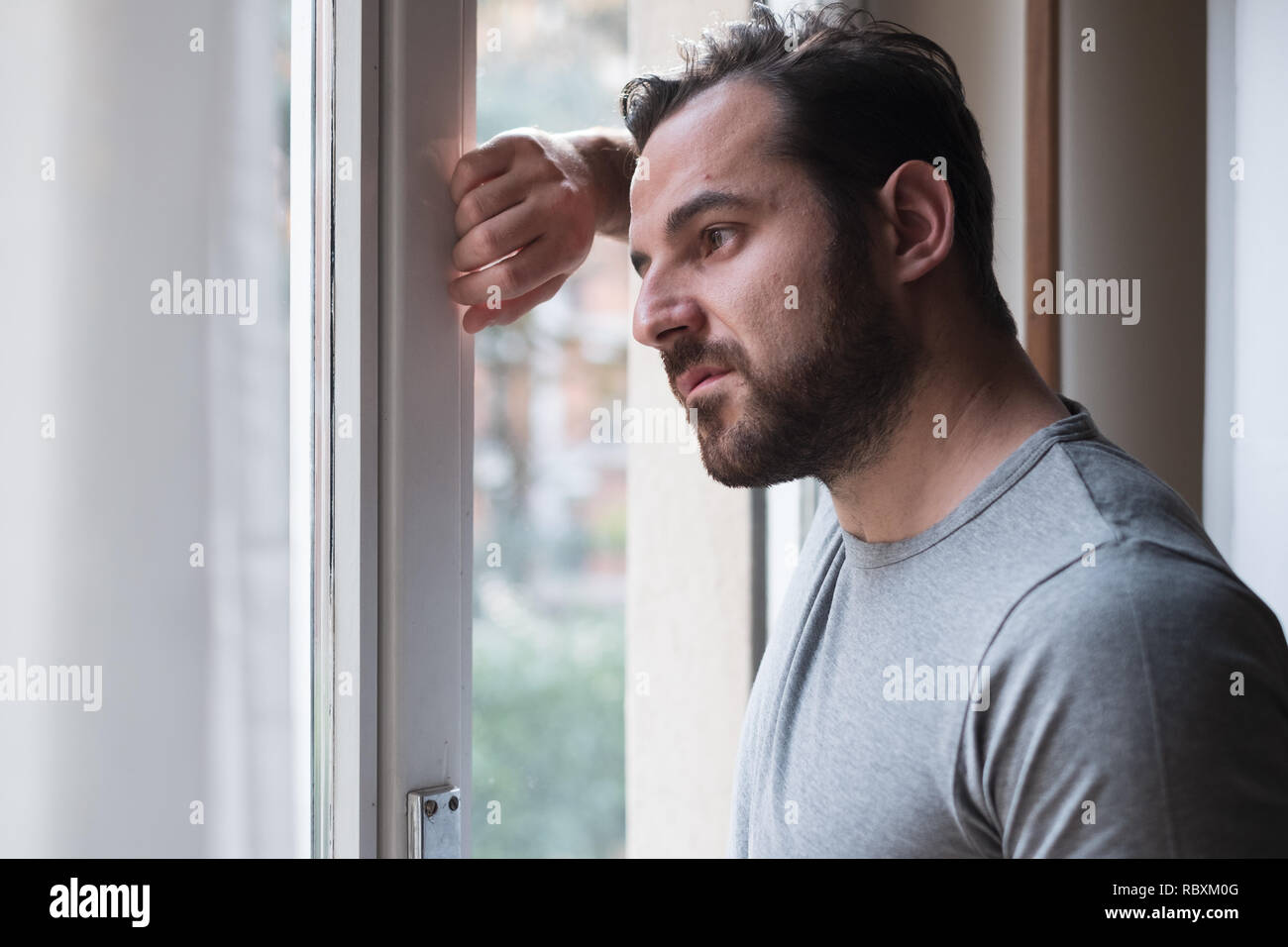 Worried man looking out of the window hi-res stock photography and ...
