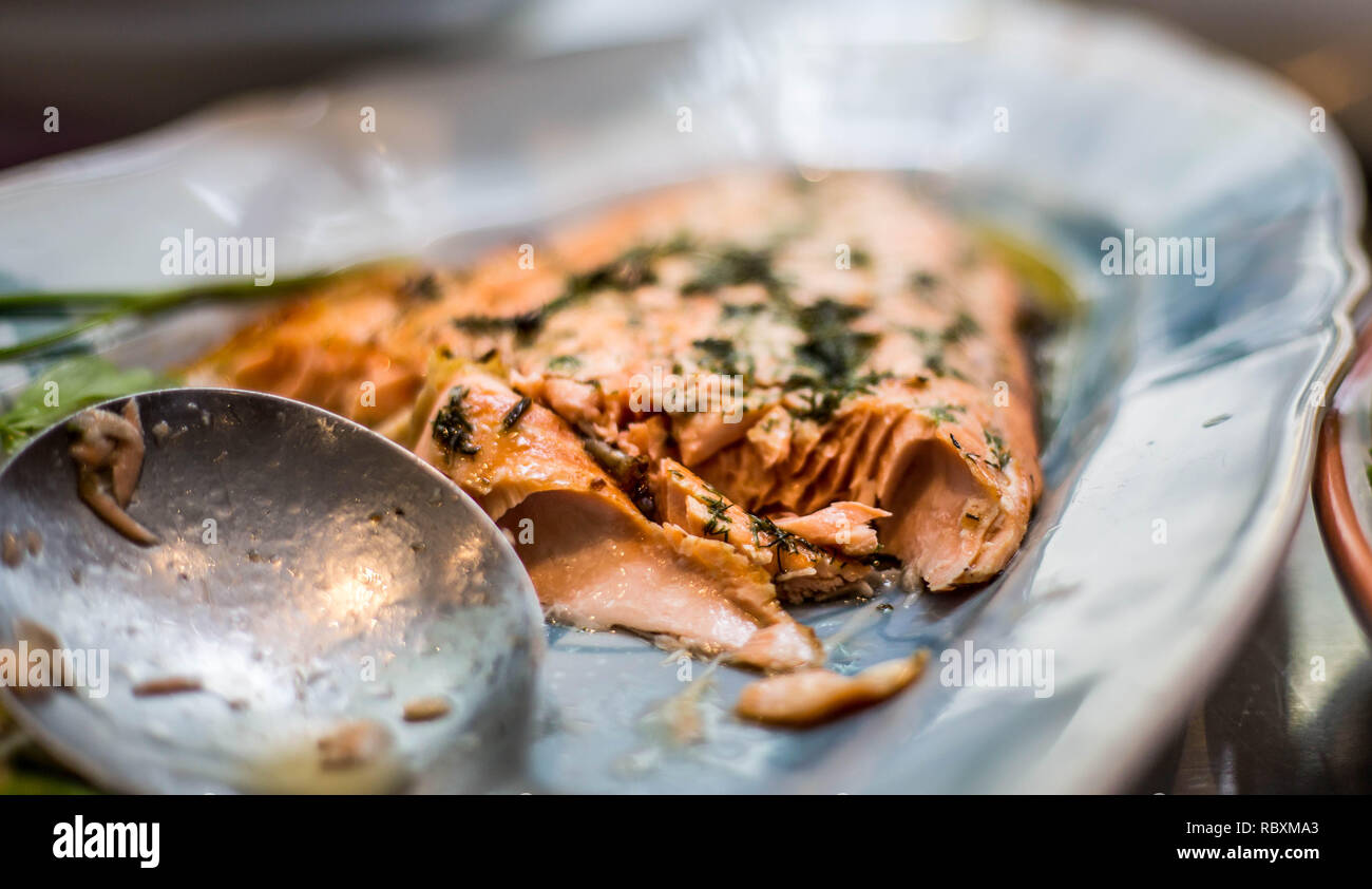 Cooked salmon on a platter with herbs Stock Photo - Alamy