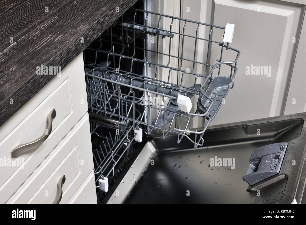 The Open dishwasher built into the kitchen Stock Photo - Alamy