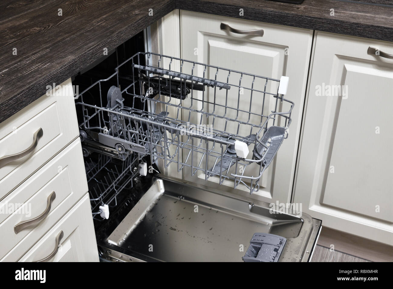 The Open dishwasher built into the kitchen Stock Photo - Alamy