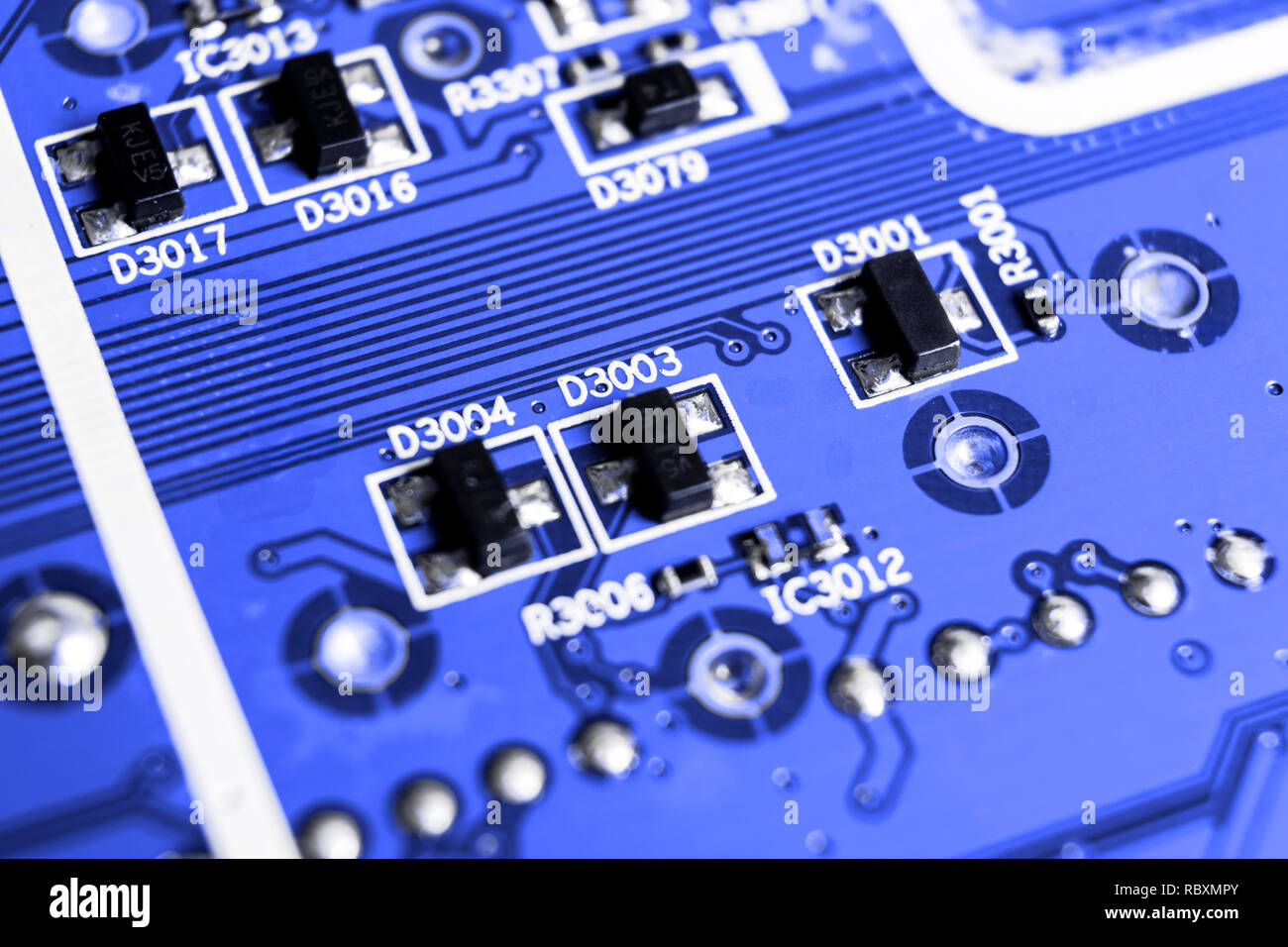Macro shot of a Circuitboard with resistors microchips and electronic ...