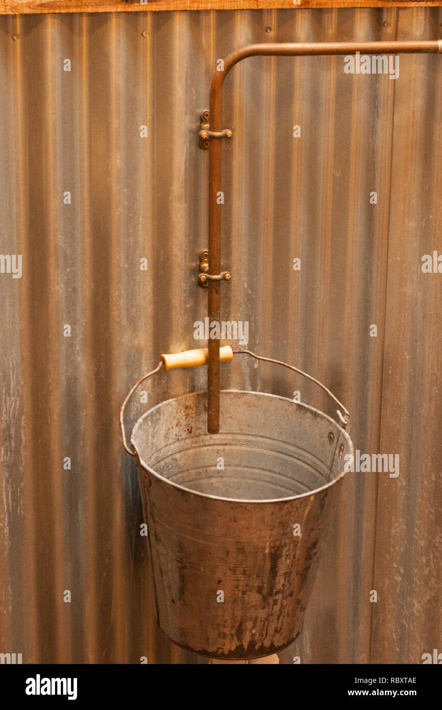 Retro bucket urinal in toilet Stock Photo - Alamy