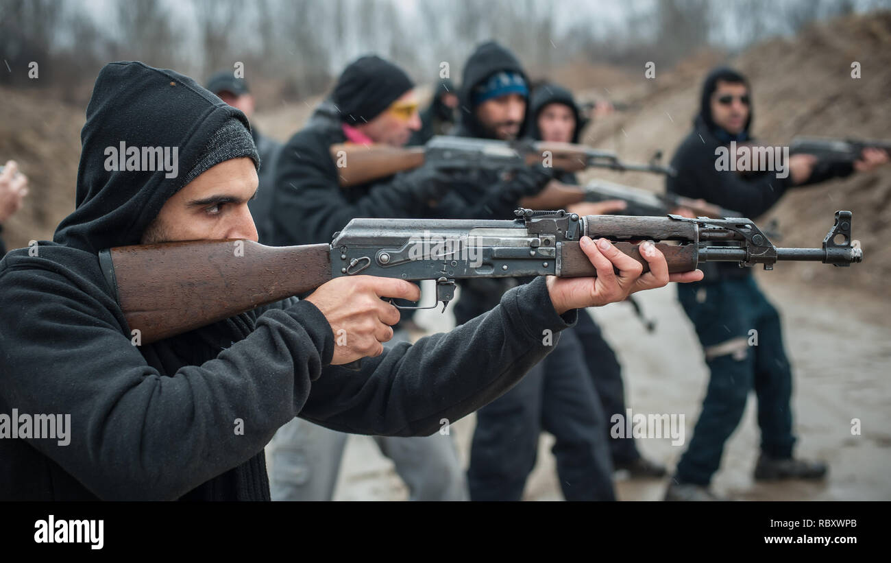 Large team, group of civilian people have action training with rifle ...
